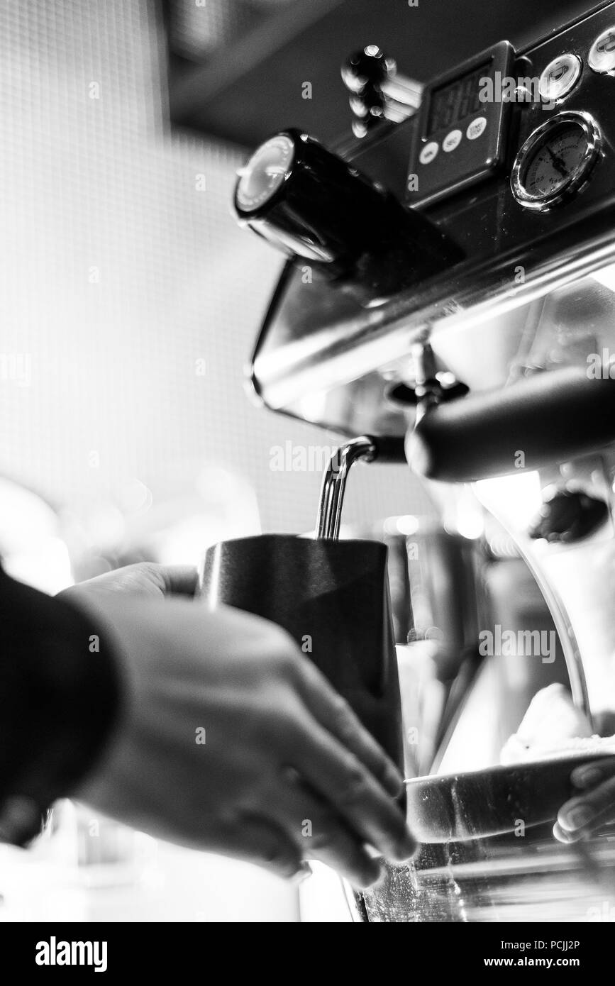 making espresso coffee BW black and white close up detail with modern ...