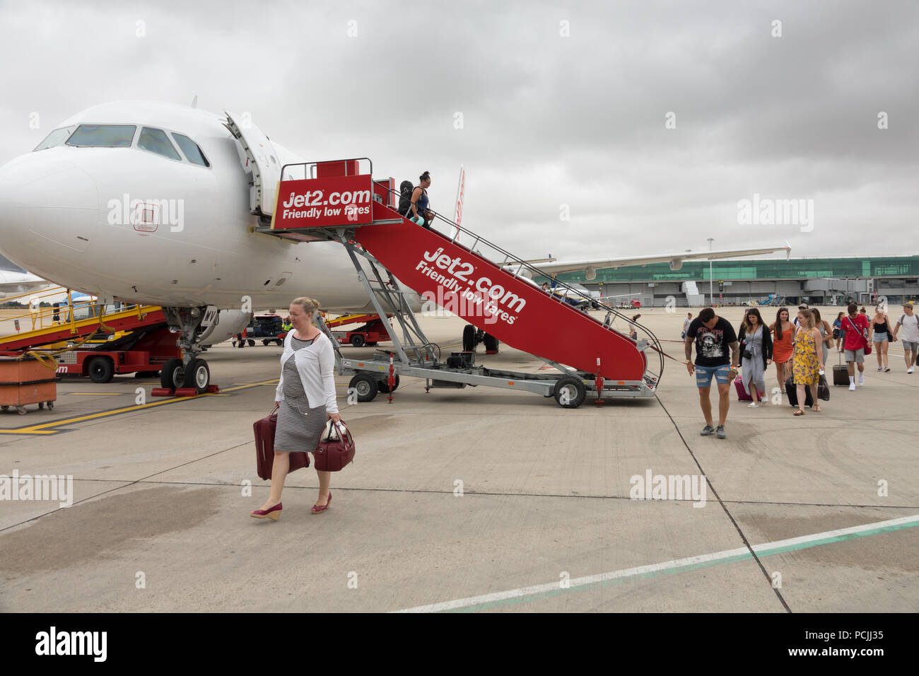 Passengers getting off an Jet2 plane at Stansted Airport,Essex Stock ...