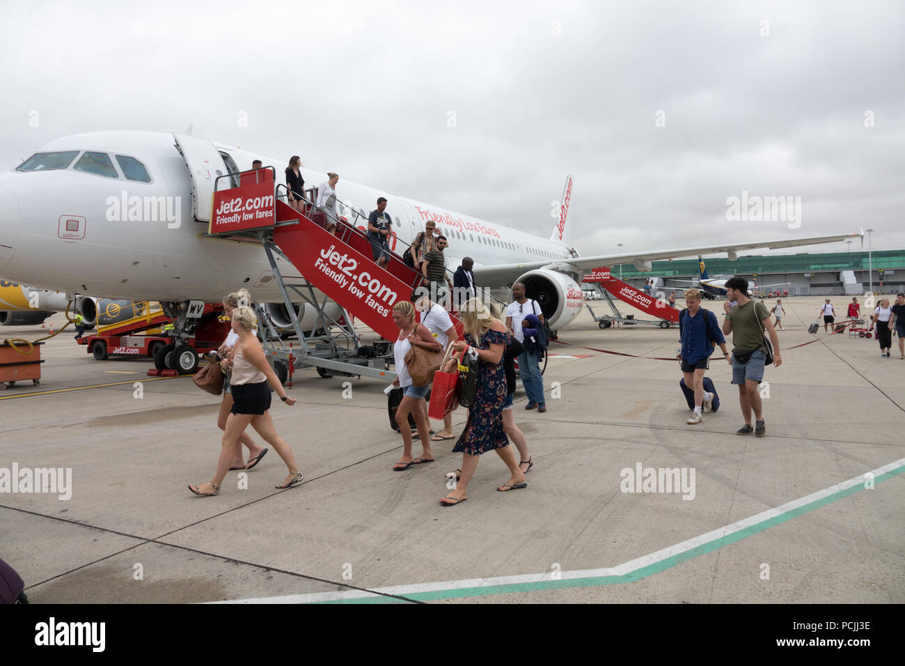 Tourists getting off plane hi-res stock photography and images - Alamy