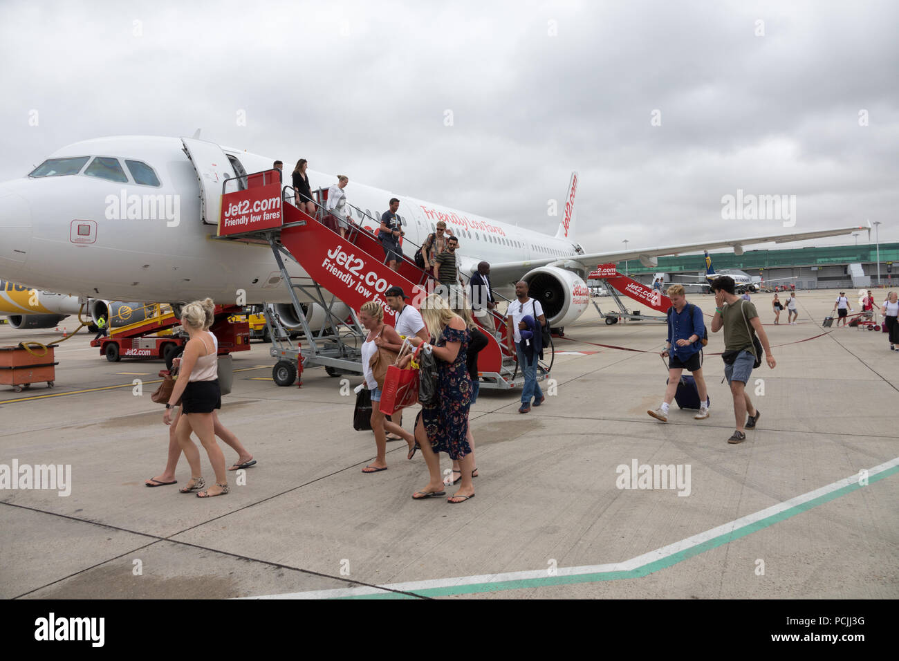 Passengers getting off an Jet2 plane at Stansted Airport,Essex Stock ...