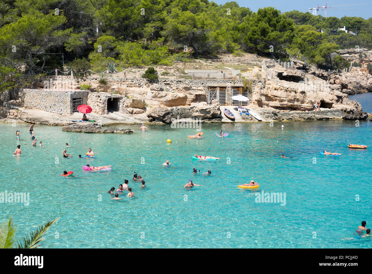 Visitors and holidaymakers in Portinatx in ibiza, Spain Stock Photo - Alamy
