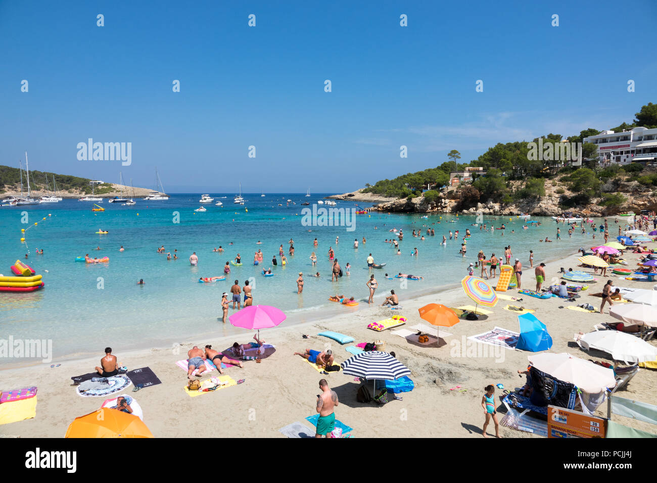 Visitors and holidaymakers in Portinatx in ibiza, Spain Stock Photo - Alamy