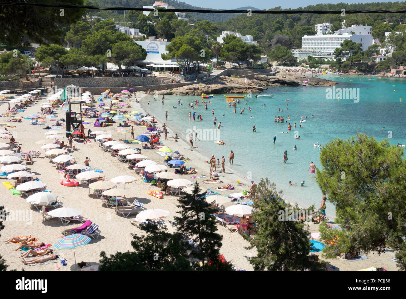 Visitors and holidaymakers in Portinatx in ibiza, Spain Stock Photo - Alamy
