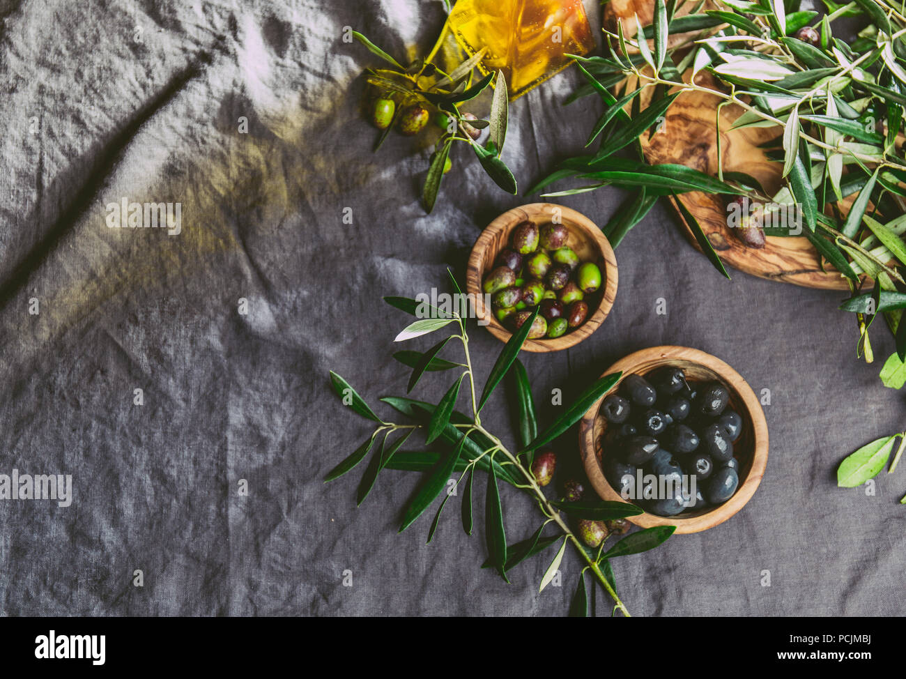 OLIVES. Olives, olives tree branch. olive oil on linen tablecloth Stock ...
