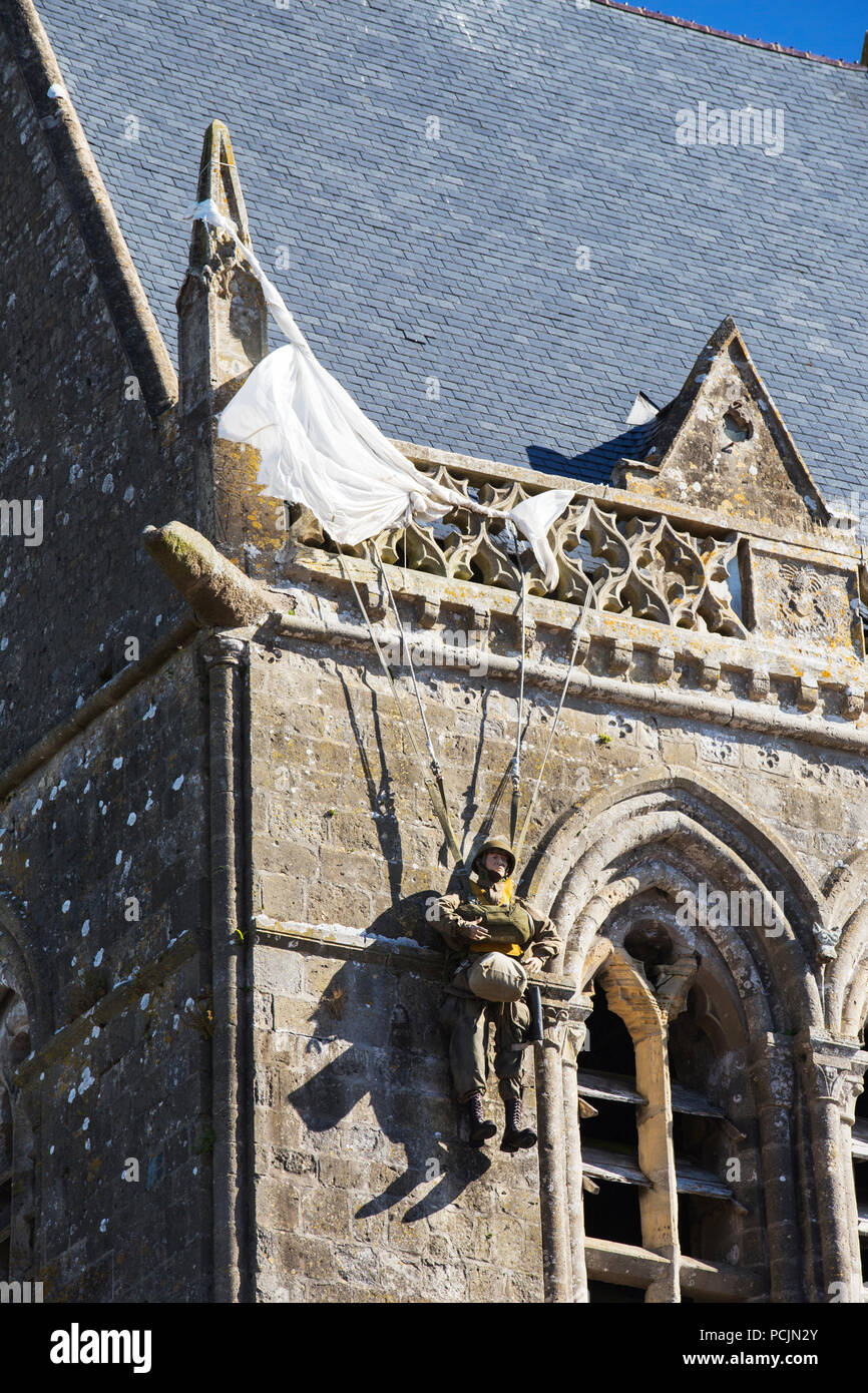 The parachute memorial on the church in Sainte Mere Eglise, to ...