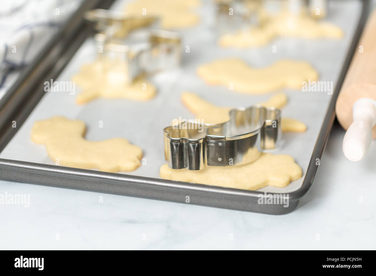 Unfinished unicorn shape sugar cookies on the baking sheet Stock Photo ...