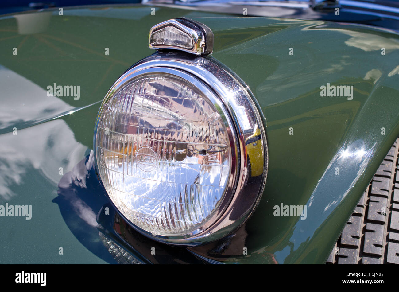 Headlight classic british sports car UK chrome Stock Photo - Alamy