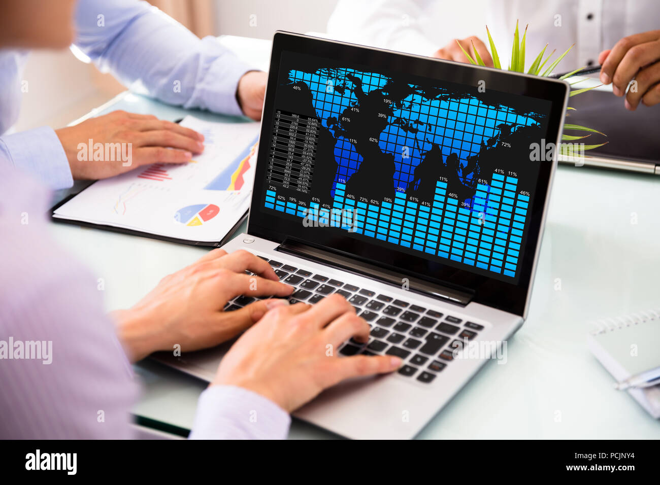 Businessperson Using Laptop With Graph On Screen Stock Photo - Alamy