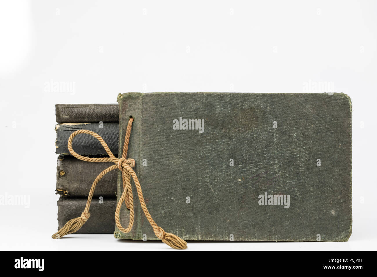 Old destroyed book on a white table. Old-style cover. White isolated ...