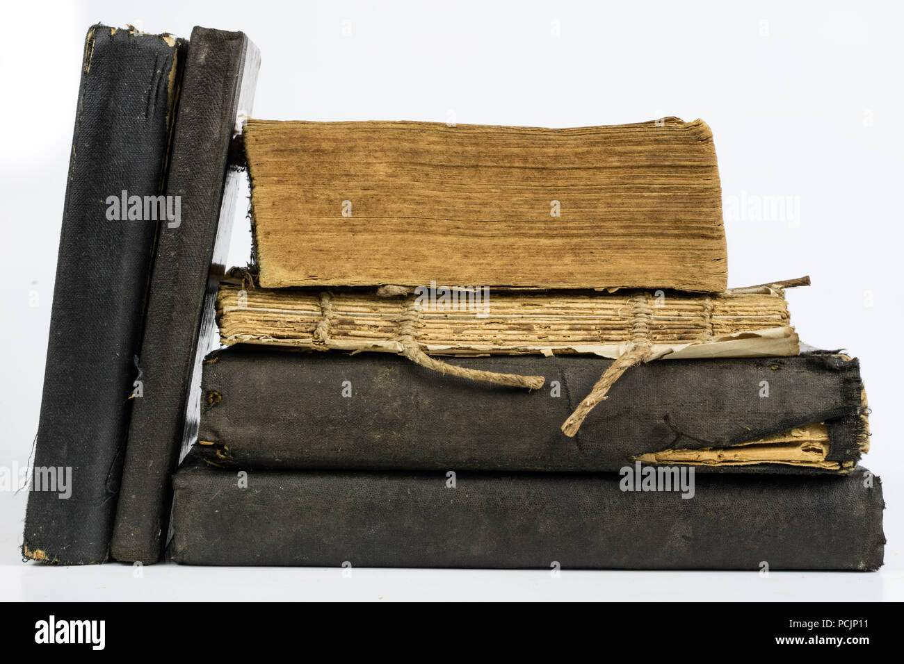 Old destroyed book on a white table. Old-style cover. White isolated ...