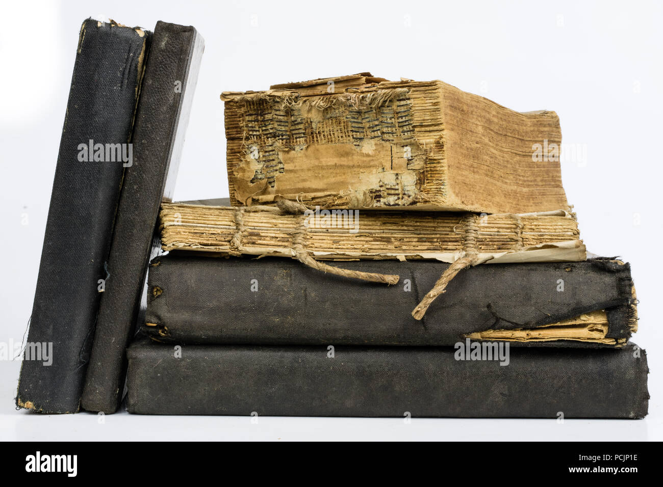 Old destroyed book on a white table. Old-style cover. White isolated ...