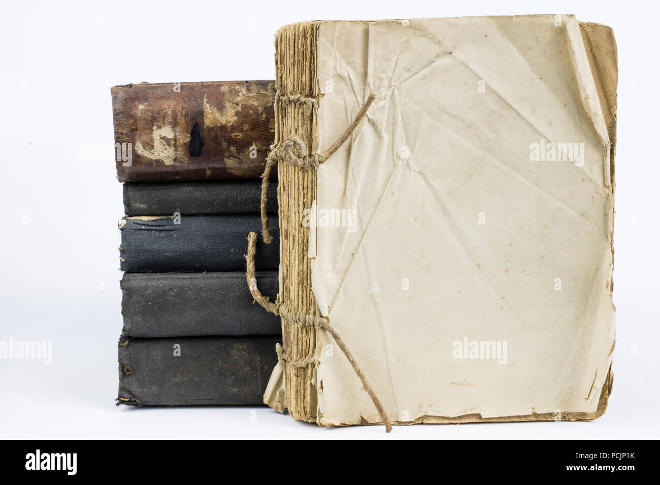 Old destroyed book on a white table. Old-style cover. White isolated ...