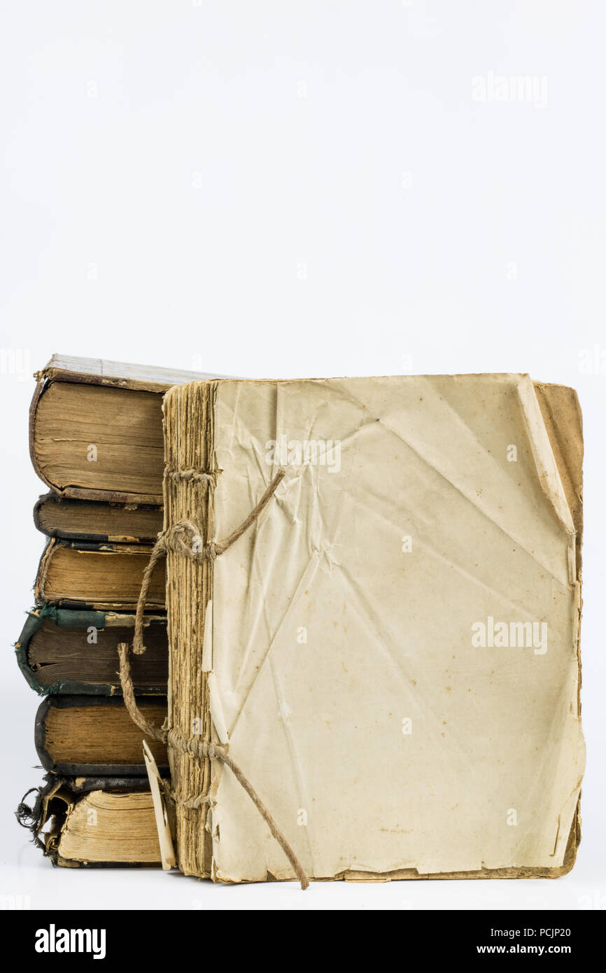 Old destroyed book on a white table. Old-style cover. White isolated ...