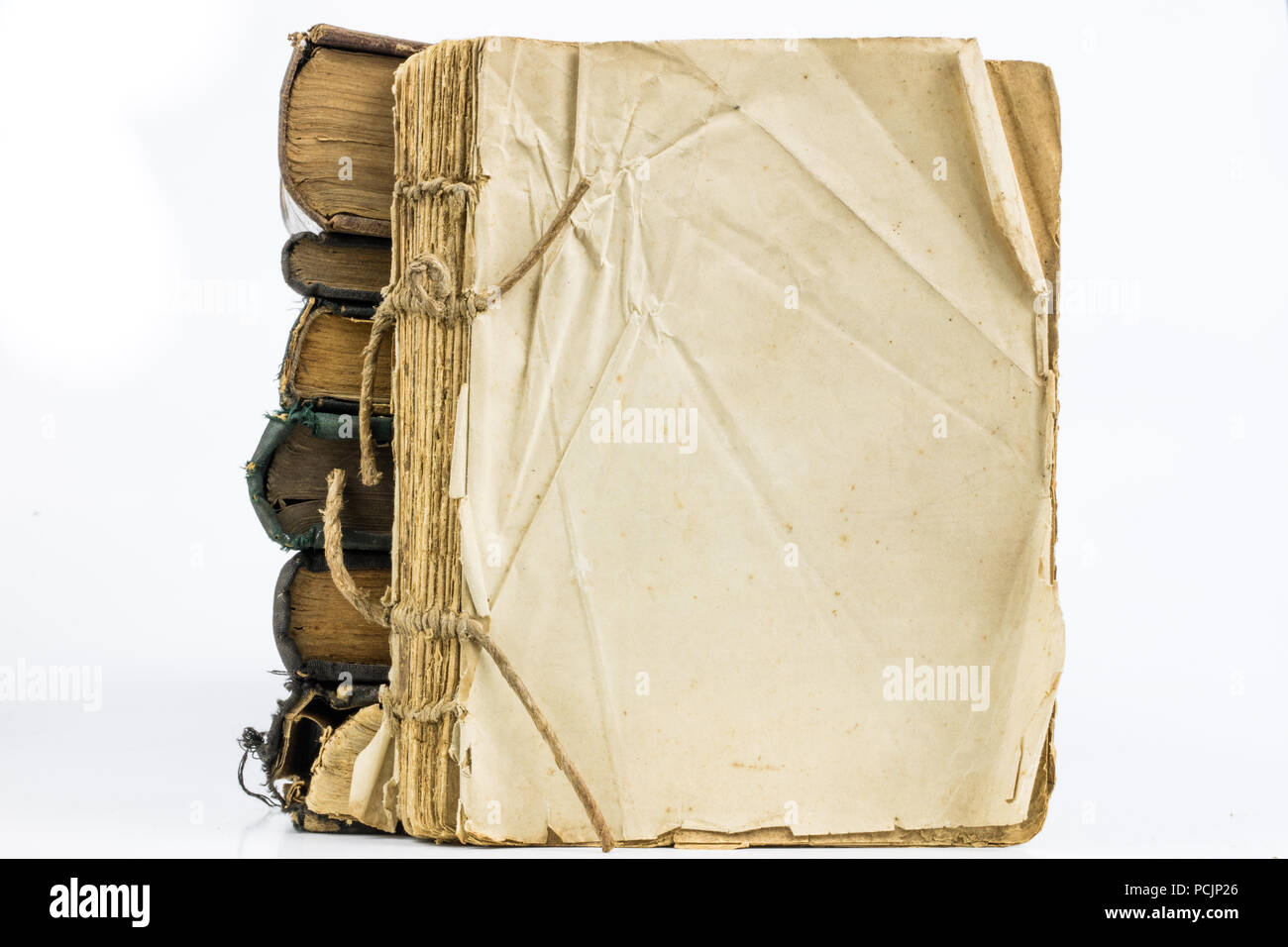 Old destroyed book on a white table. Old-style cover. White isolated ...