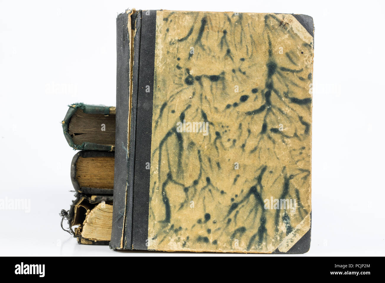 Old destroyed book on a white table. Old-style cover. White isolated ...