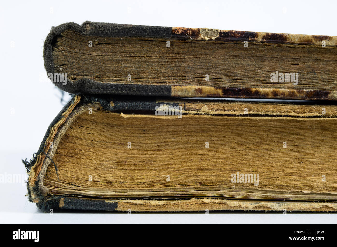 Old destroyed book on a white table. Cards and the back of an old ...