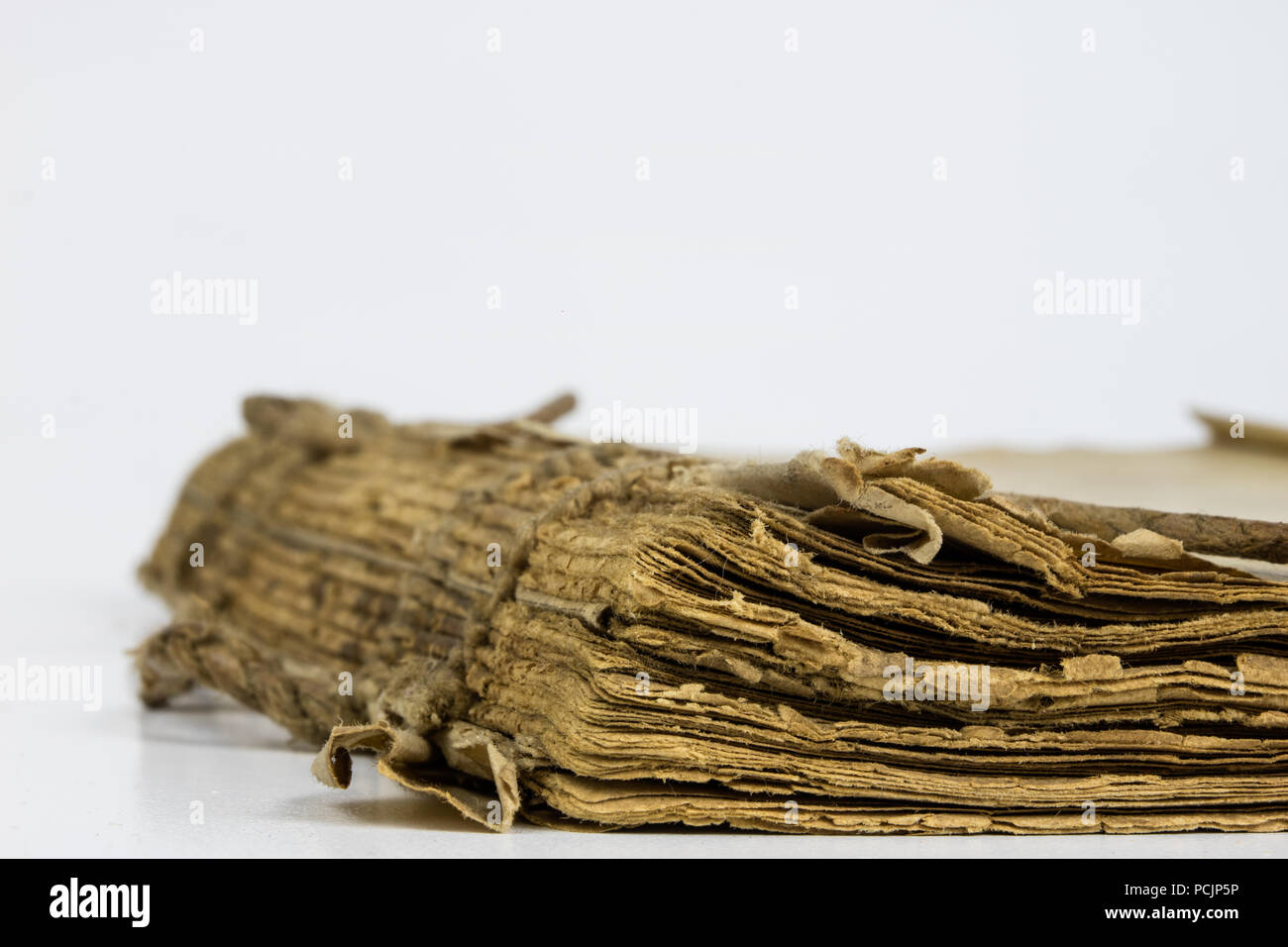 Old destroyed book on a white table. Cards and the back of an old ...