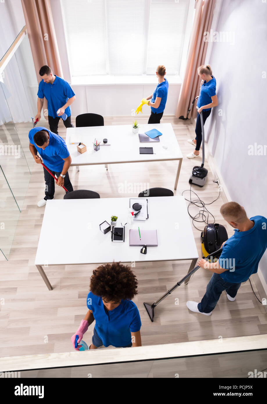 High Angle View Of Janitors In Uniform Cleaning Modern Office Stock ...