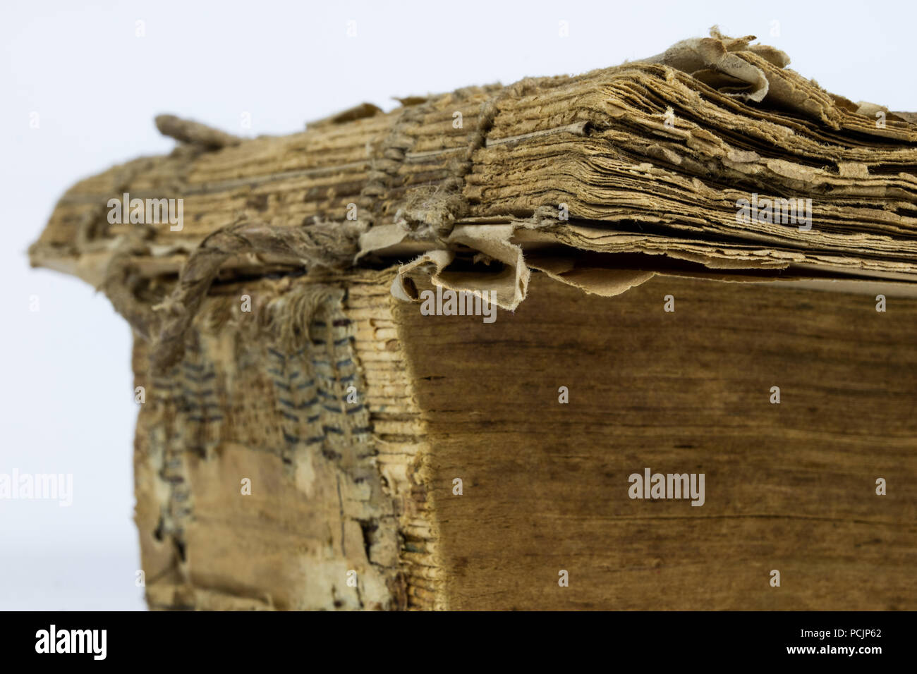 Old destroyed book on a white table. Cards and the back of an old ...