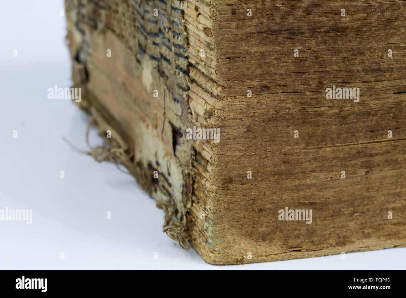 Old destroyed book on a white table. Cards and the back of an old ...