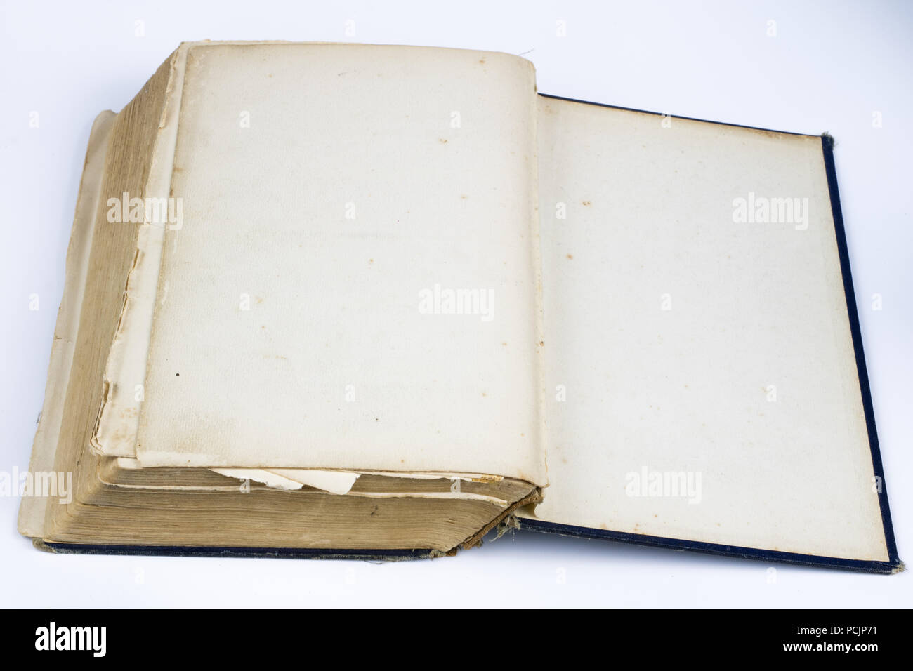 Old destroyed book on a white table. Old-style cover. White isolated ...
