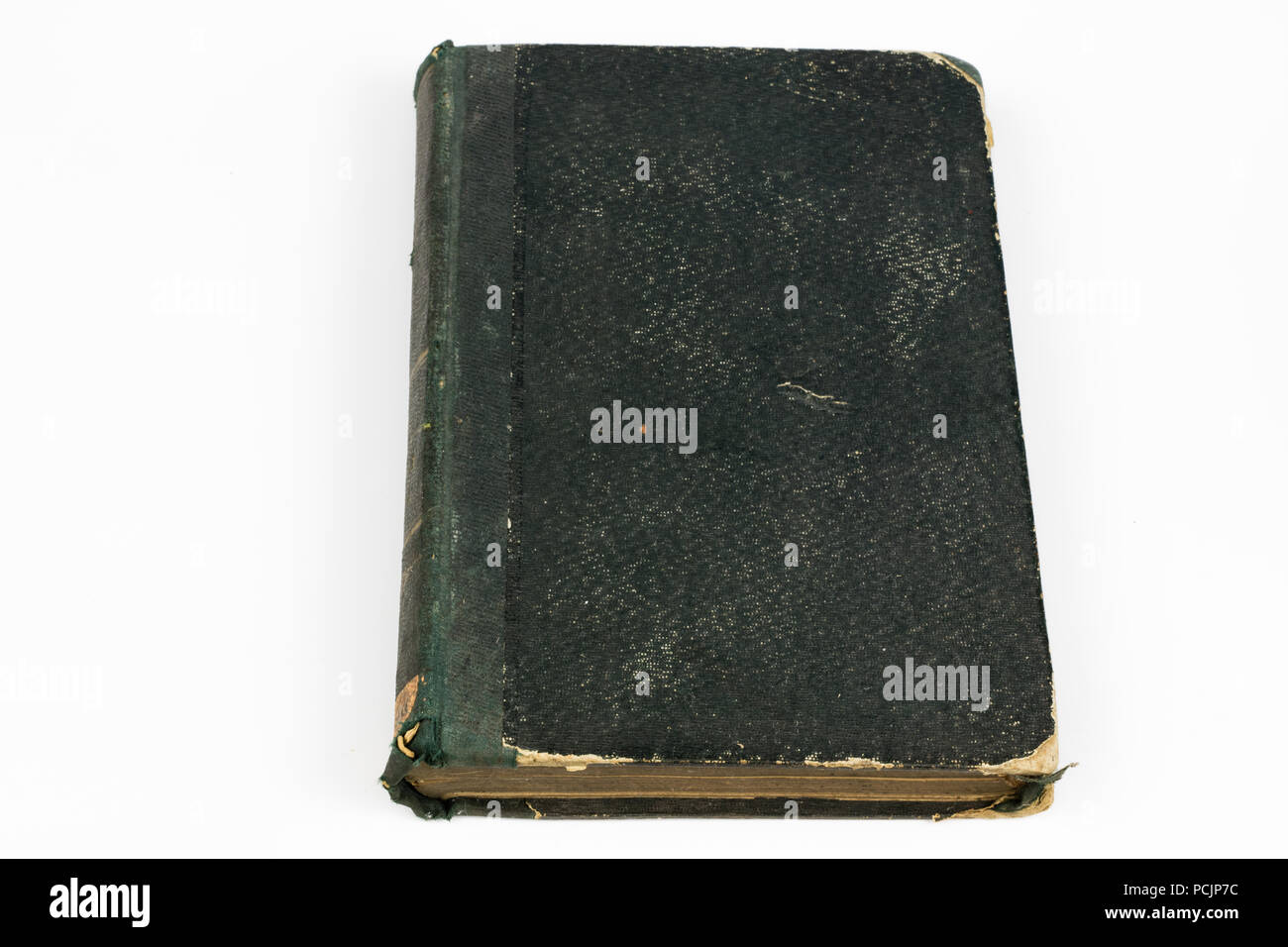 Old destroyed book on a white table. Old-style cover. White isolated ...