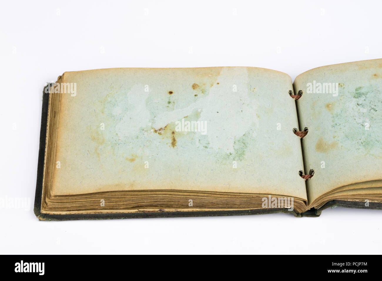 Old destroyed book on a white table. Old-style cover. White isolated ...