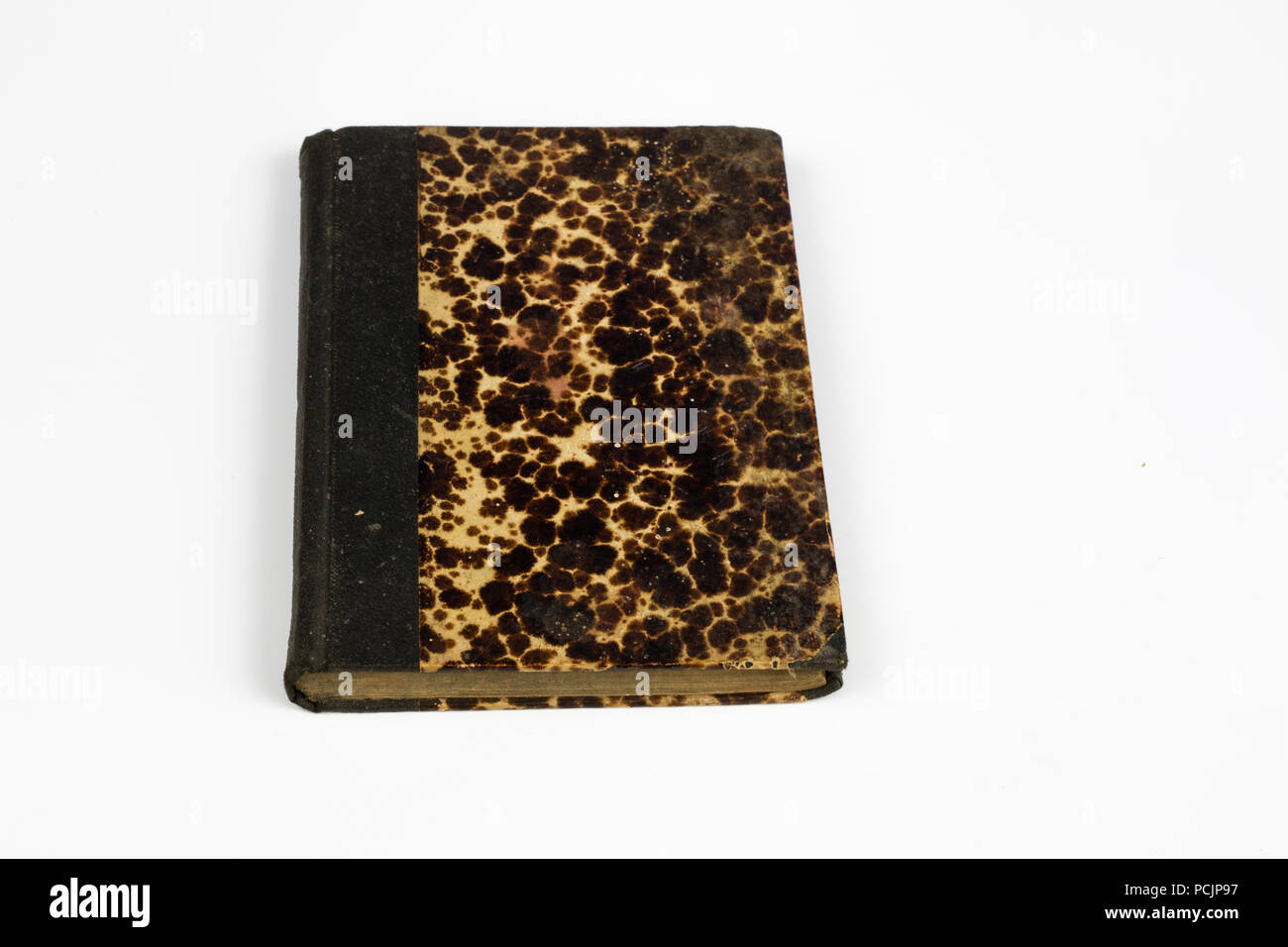 Old destroyed book on a white table. Old-style cover. White isolated ...