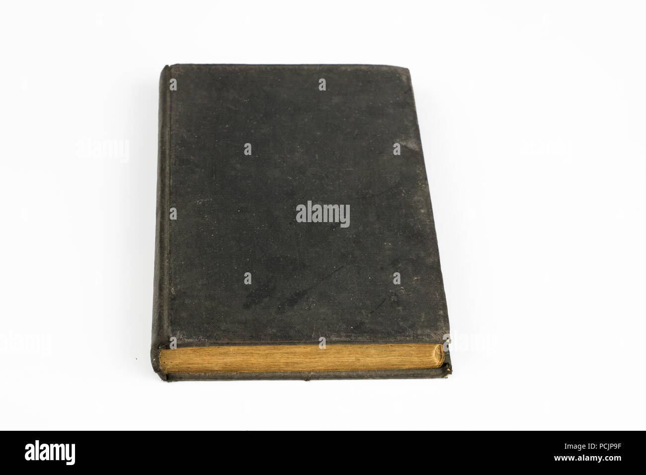 Old destroyed book on a white table. Old-style cover. White isolated ...