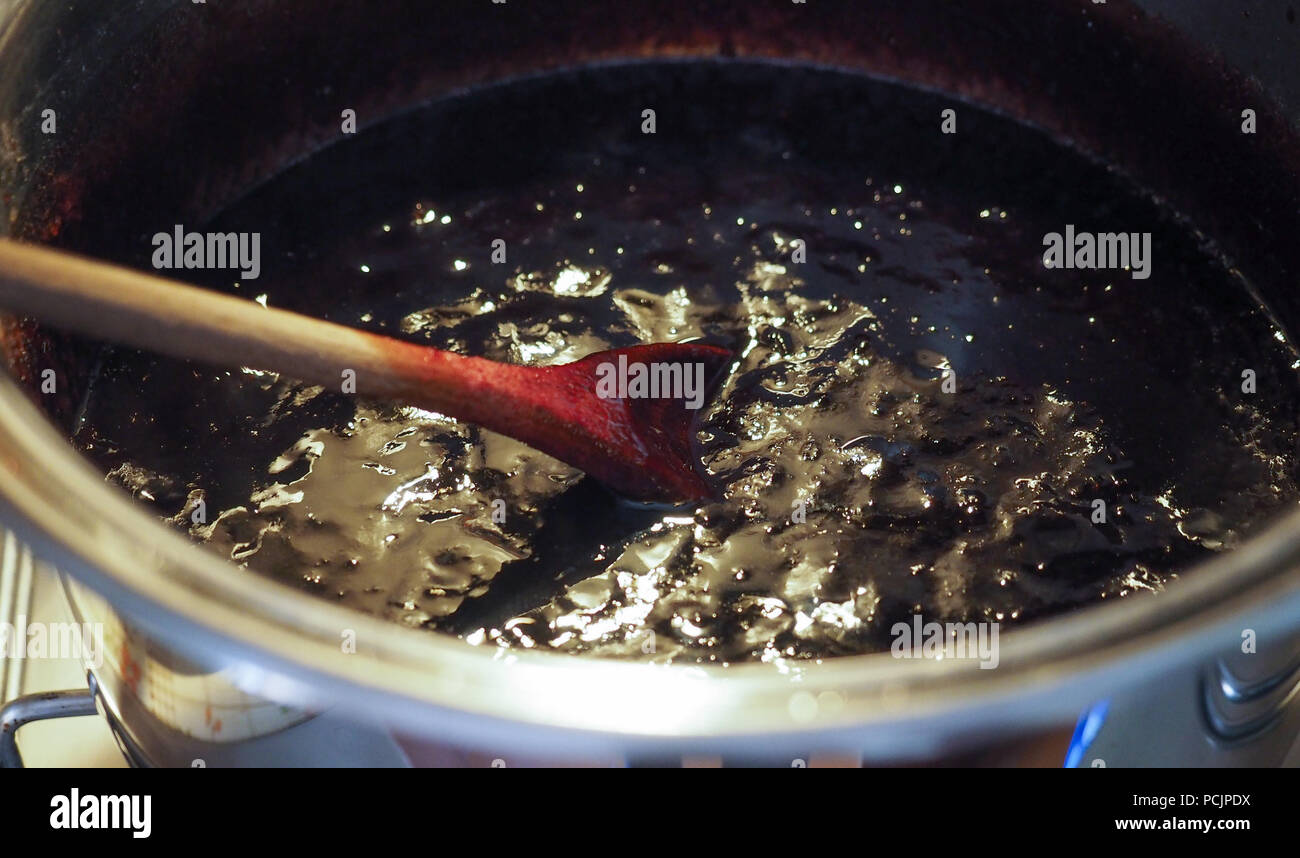 Prune fruit jam boiling in a pot Stock Photo - Alamy