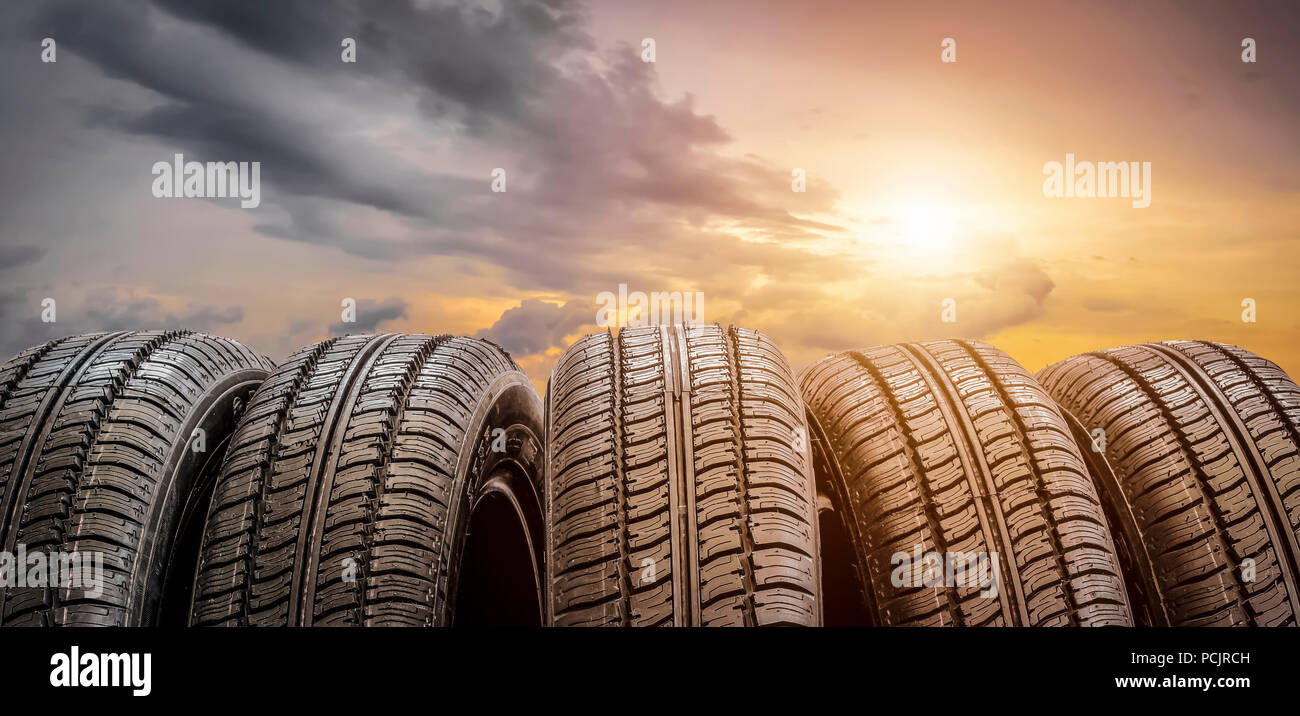 Set of car wheels on sunset background Stock Photo - Alamy