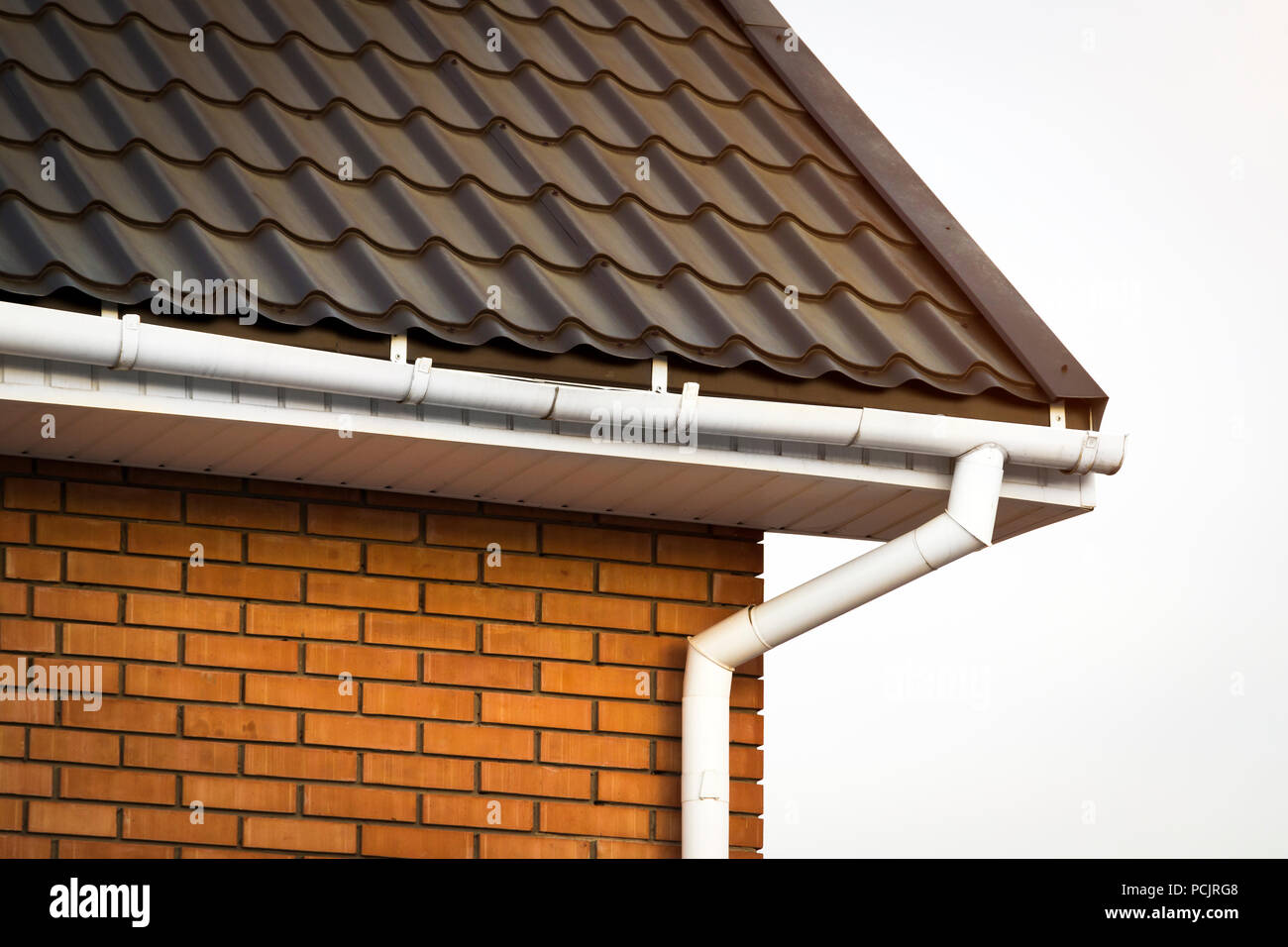 White drain on a private brick house Stock Photo - Alamy