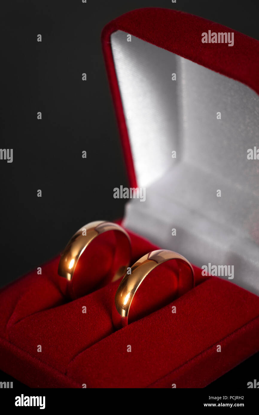 Two wedding rings in a red box on a black background close-up Stock ...