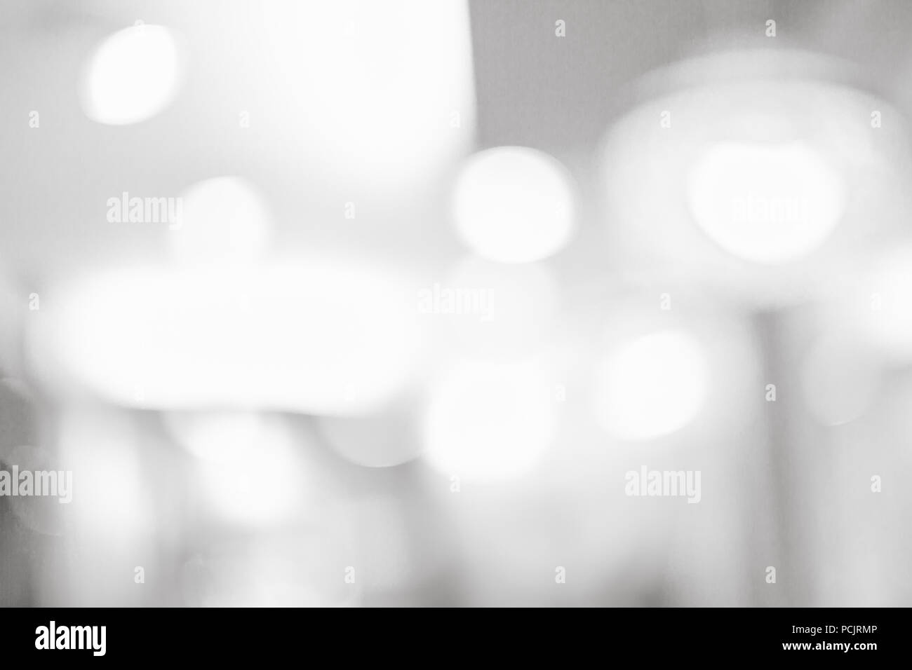 Grey or White blurred of department store background. Defocused blur ...