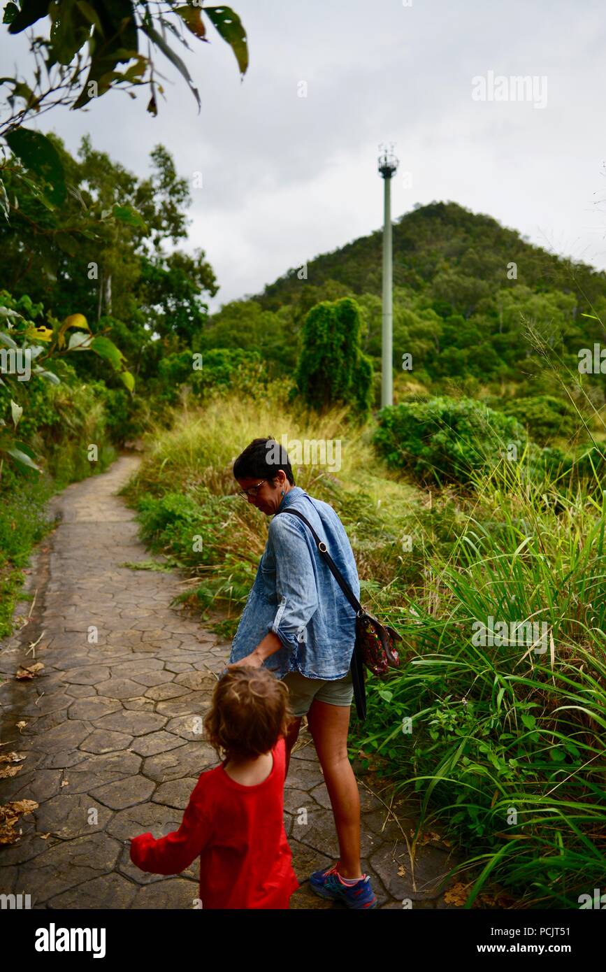 Mother and daughter walk down the track from Panjoo lookout, Cardwell ...