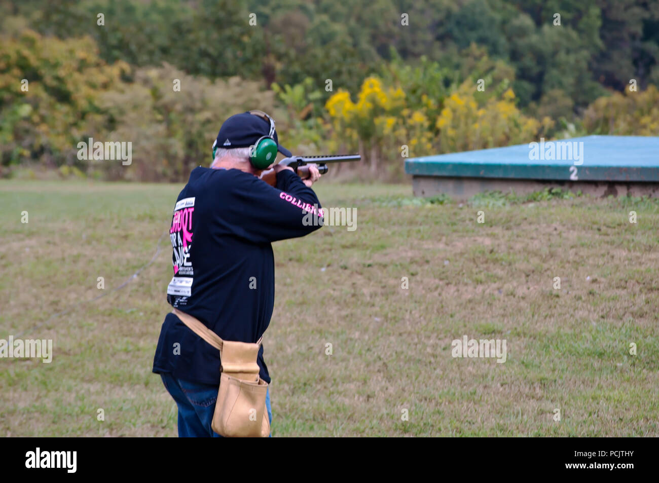 A trap shooter on the line with his shotgun at the Collier's Sportman ...