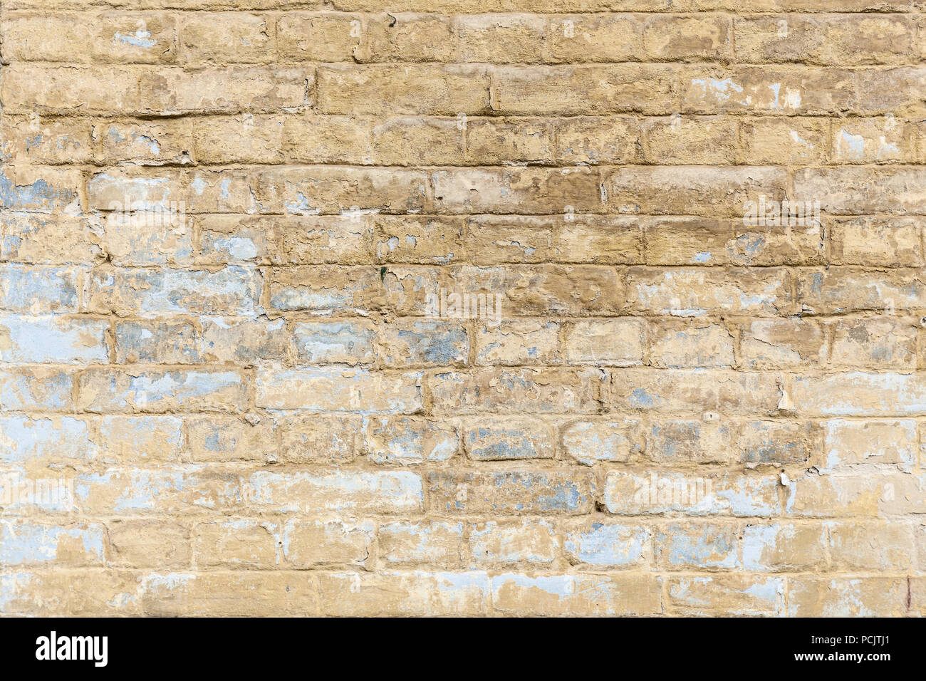 Brick wall. Brick wall with bricks of different size and shape of sand ...