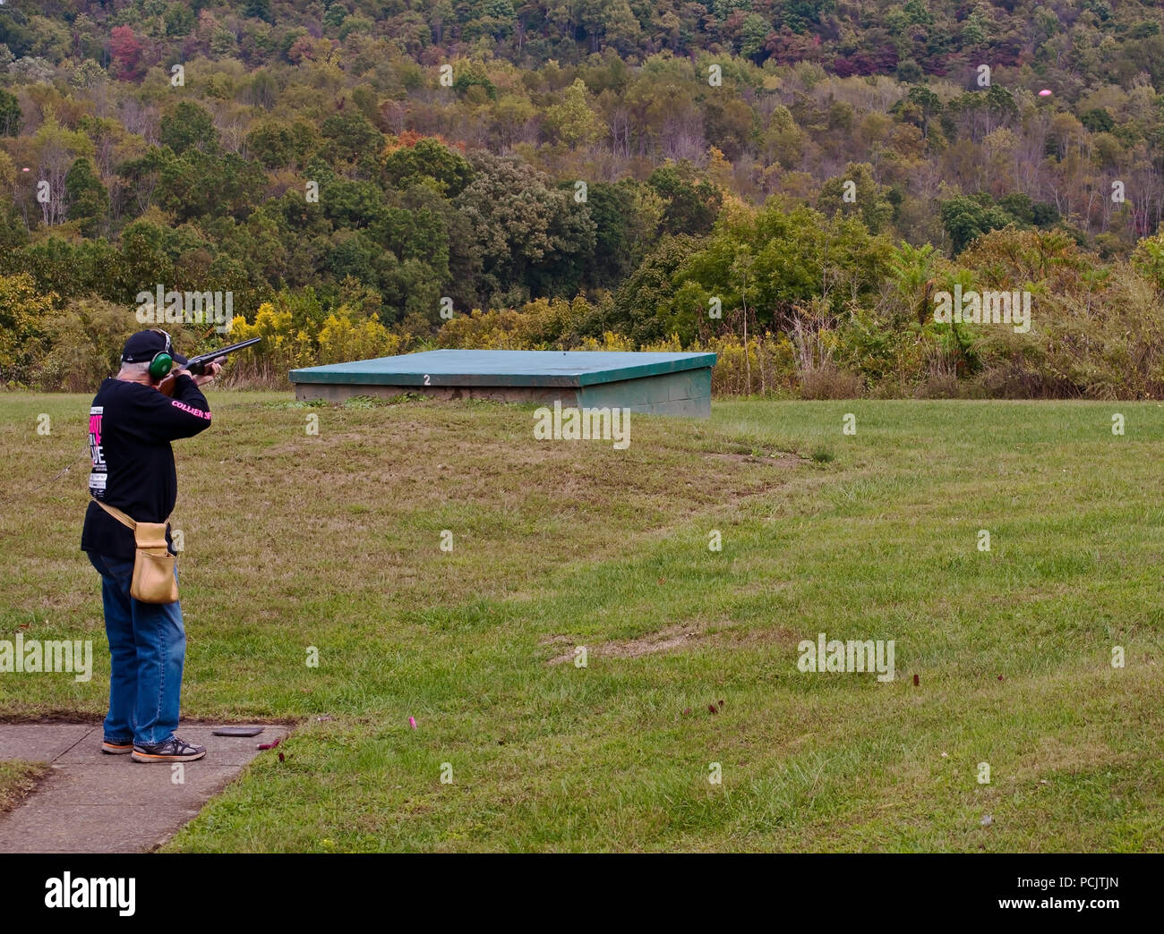 A trap shooter on the line with his shotgun at the Collier's Sportman ...