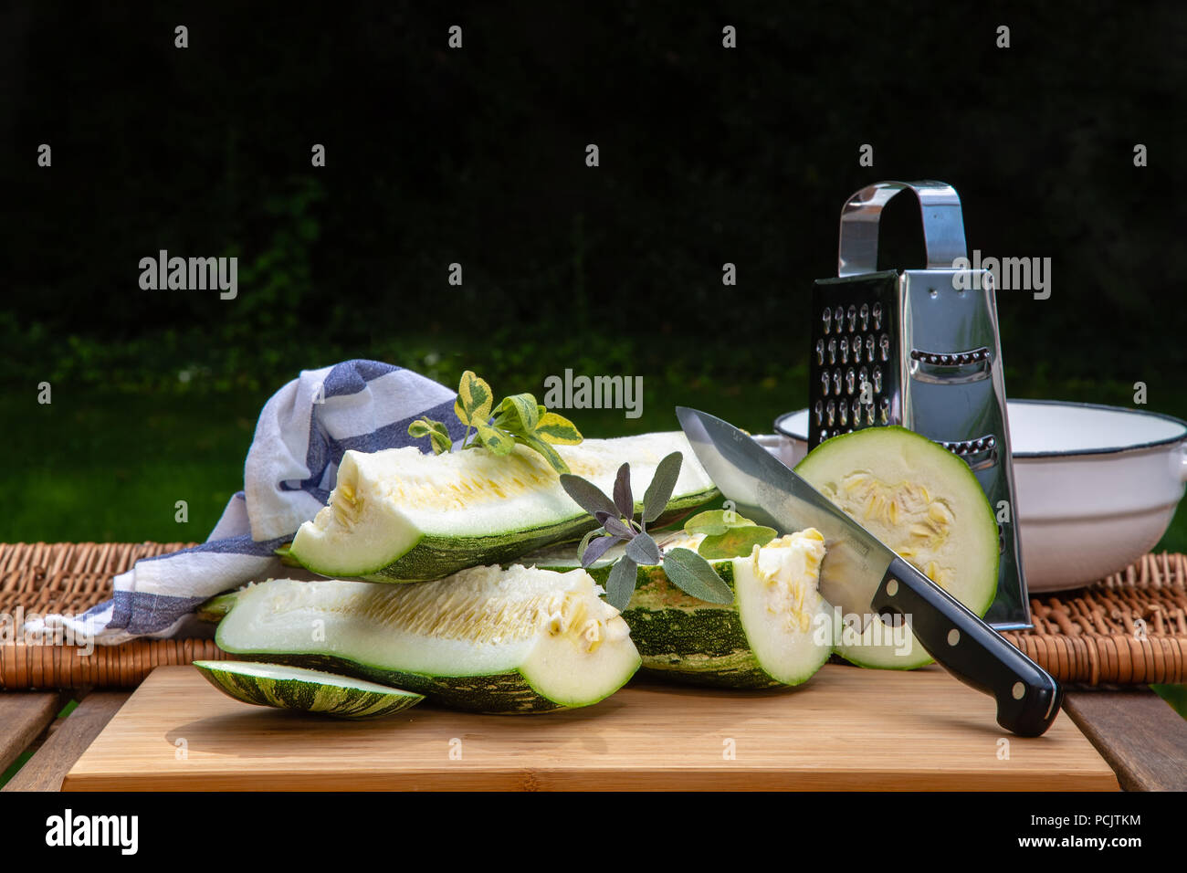 Chopped large spotted zucchini in the garden on the table Stock Photo ...