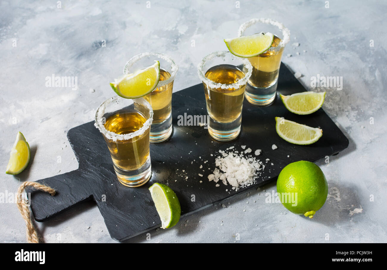Mexican gold tequila with lime and salt on black stone background Stock ...