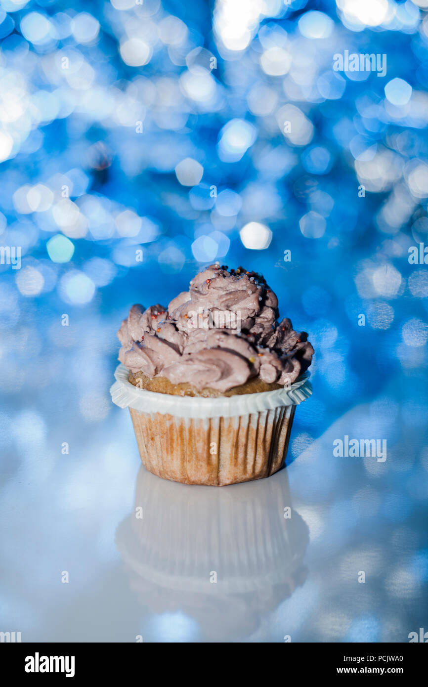 Iced cupcake with cool freezing blue background Stock Photo - Alamy
