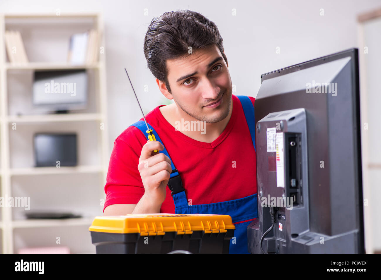 Professional repair engineer repairing broken tv Stock Photo - Alamy