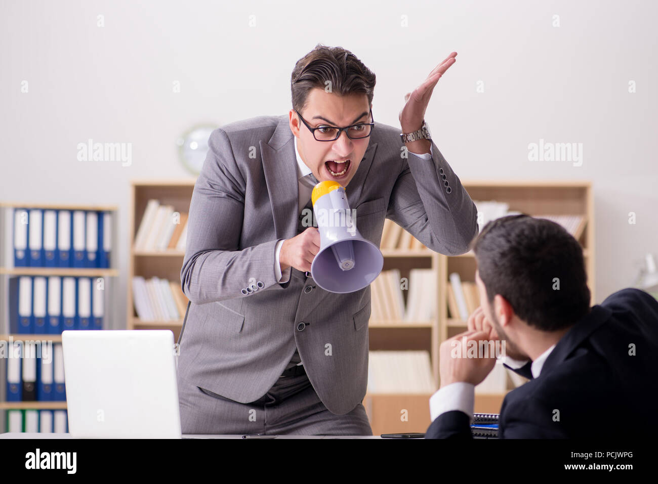 Angry boss shouting at his employee Stock Photo - Alamy