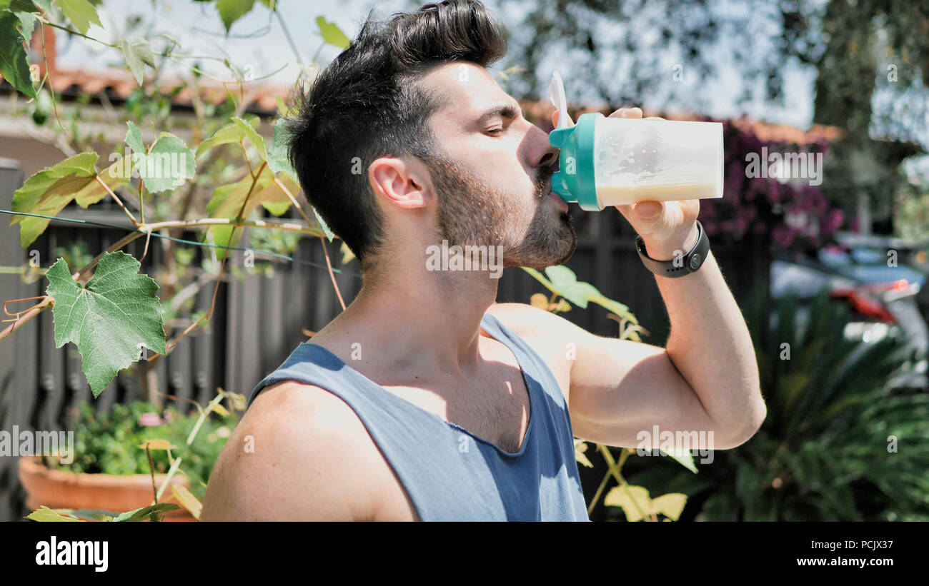 Man drinking protein shaker from blender Stock Photo - Alamy