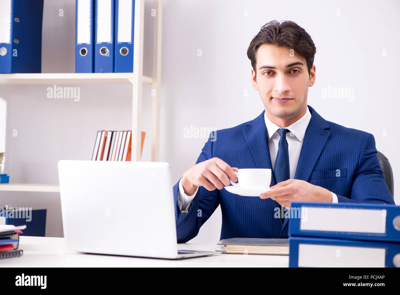 Young handsome businessman employee working in office at desk Stock ...