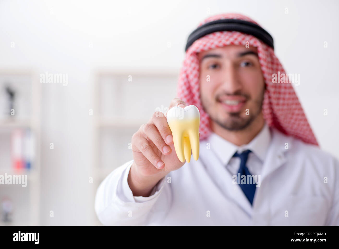 Arab dentist working on new teeth implant Stock Photo - Alamy
