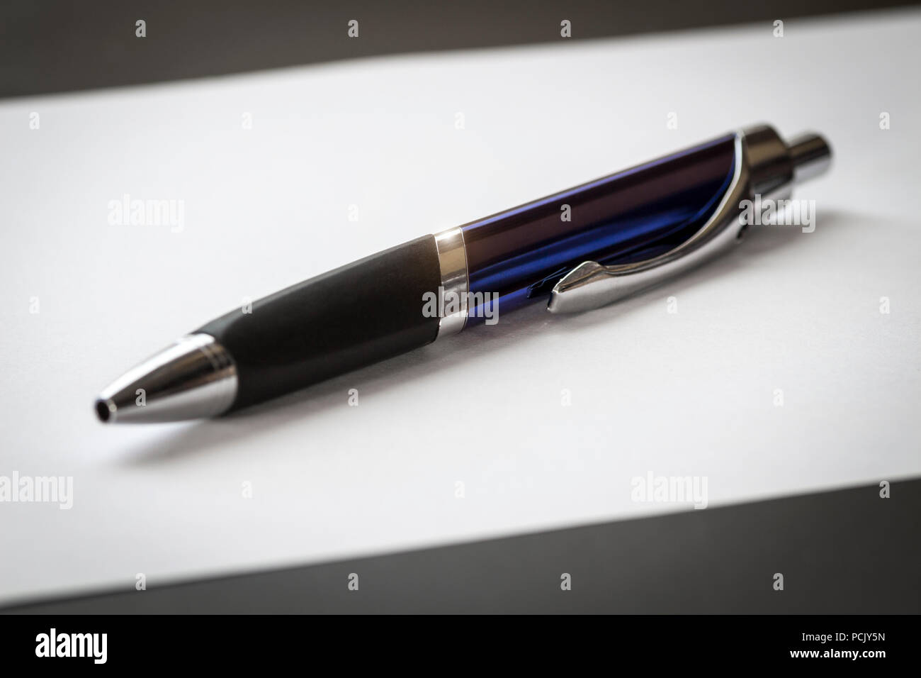 Office ballpoint pen lies on a sheet of paper close-up Stock Photo - Alamy