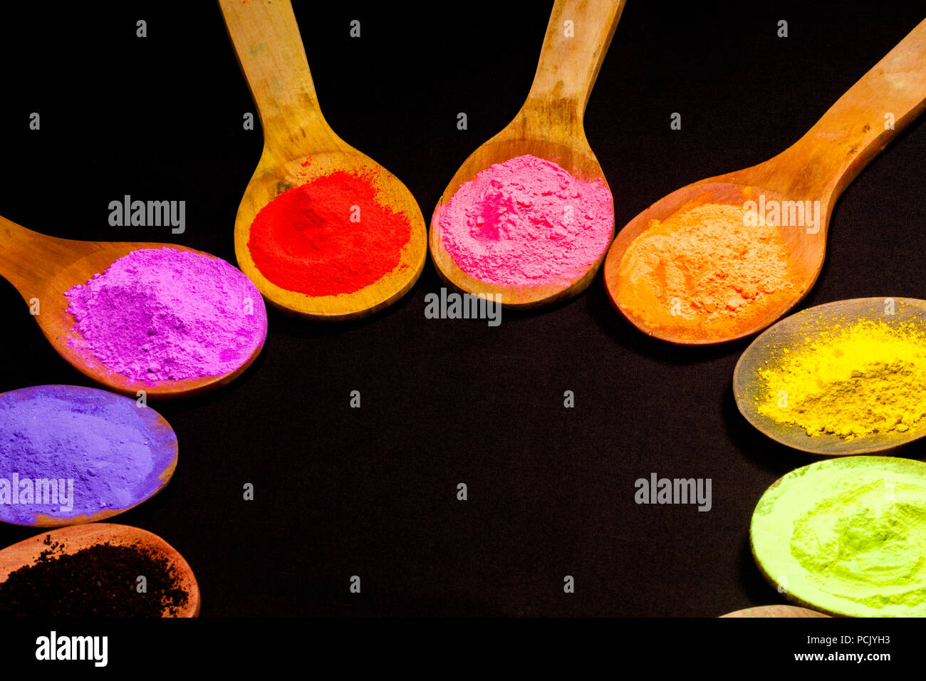 colourful powder paint on black fabric. colourful powder paint in ...