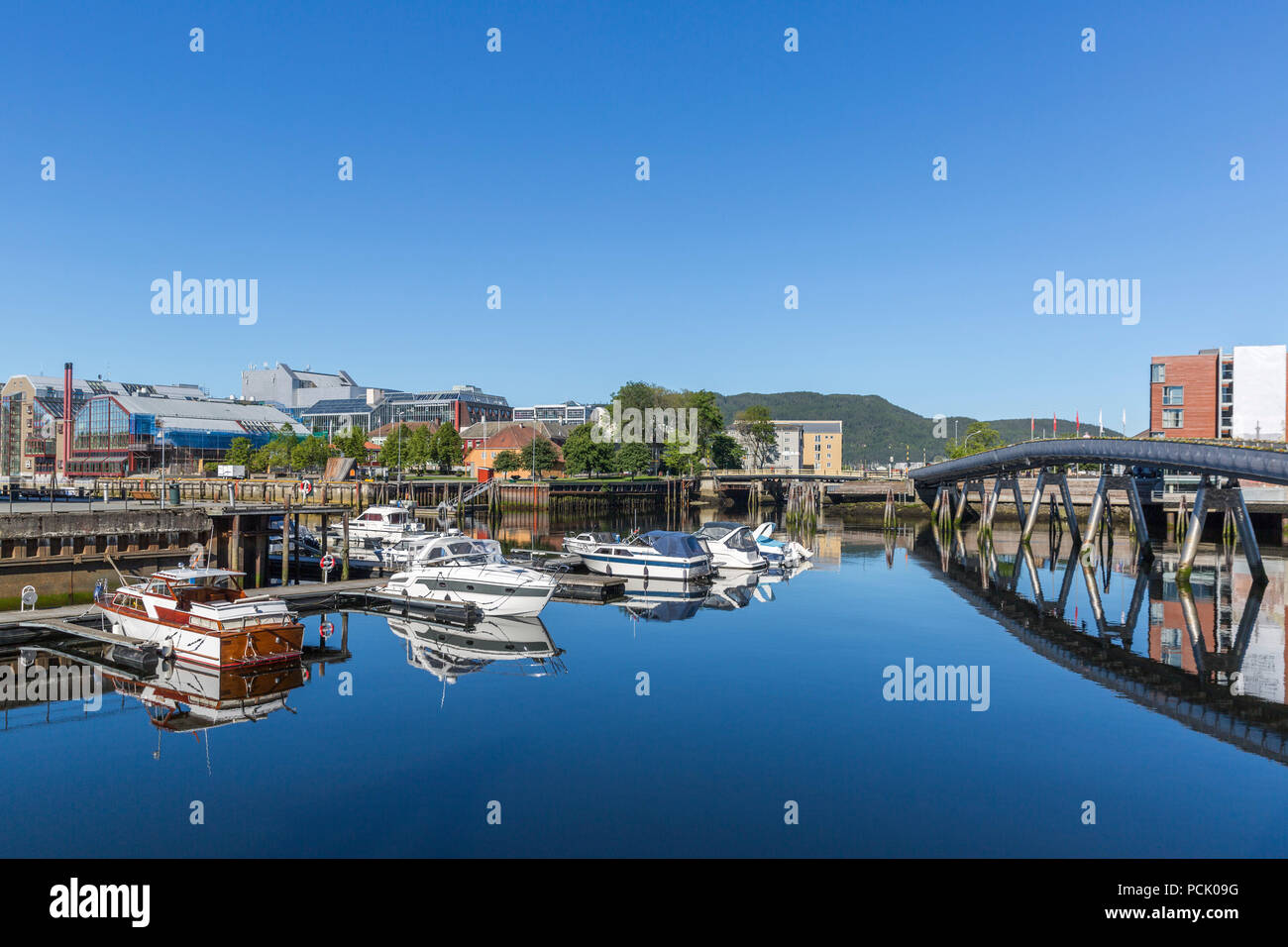 Beautiful cityscape of Trondheim with yachts and pedestrian bridge ...