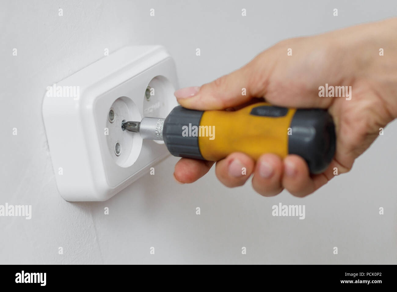electrician installing electrical socket Stock Photo - Alamy